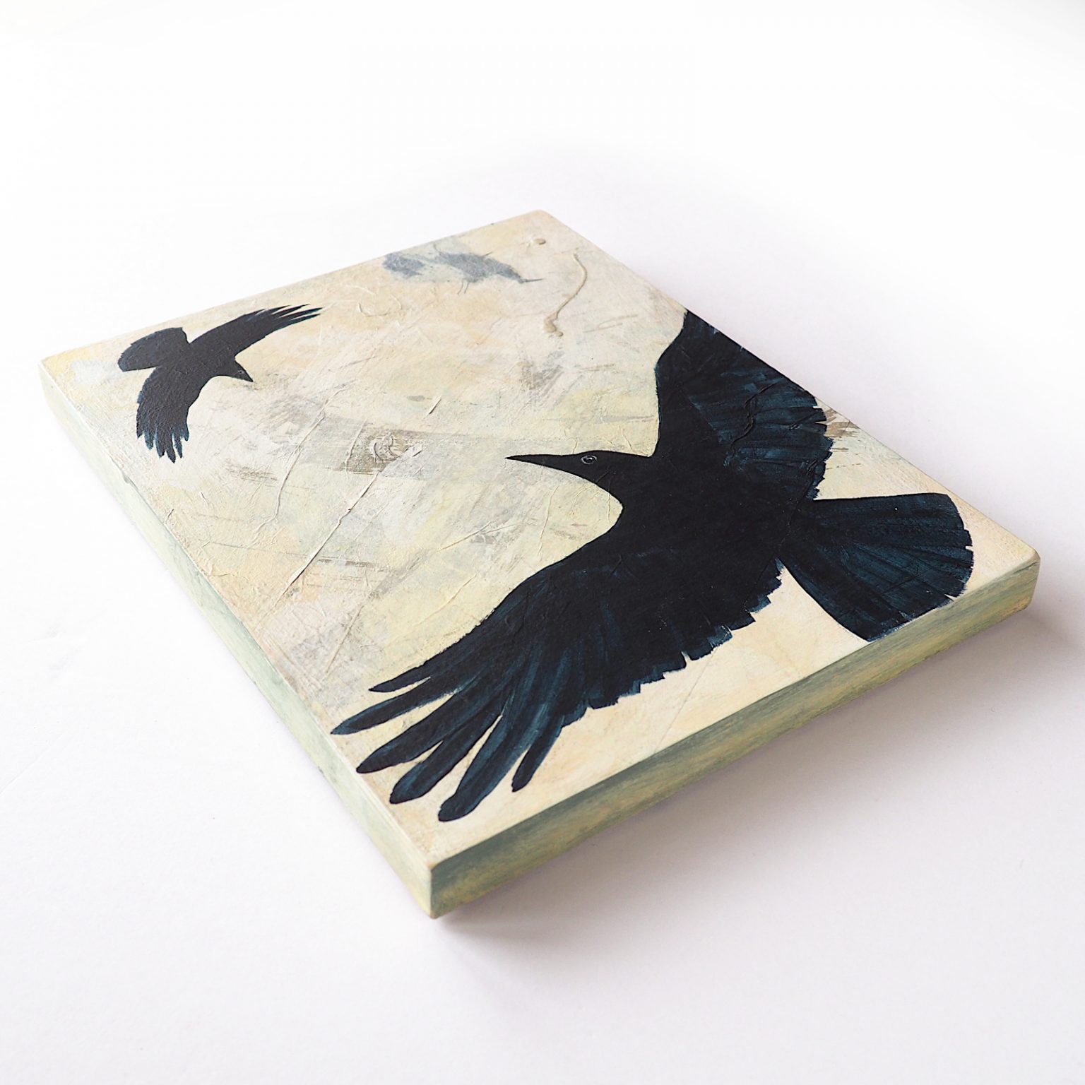 Two ravens in flight, mixed media on panel - Clare Rosen Studio
